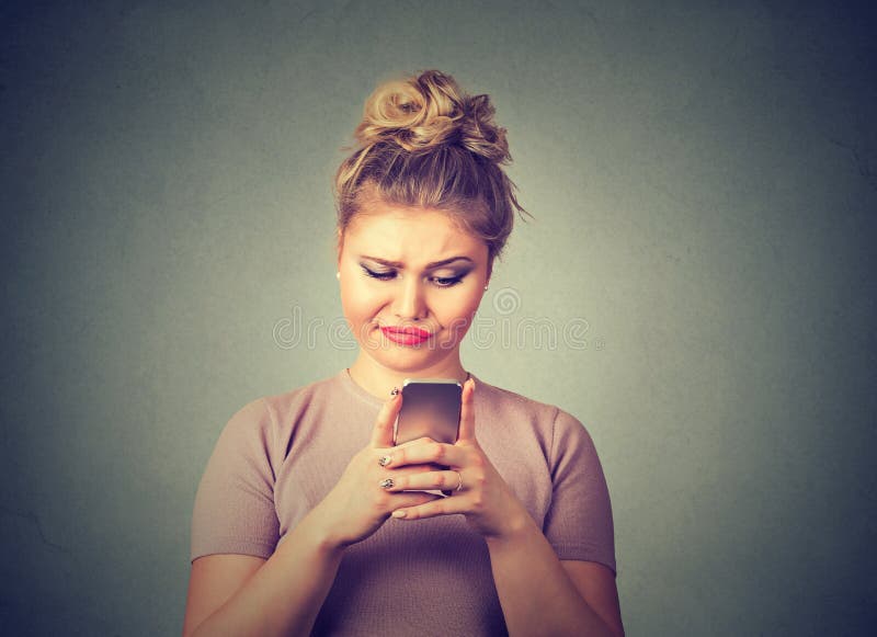 Sad Skeptical Unhappy Woman Texting On Phone Outdoors In Park Stock