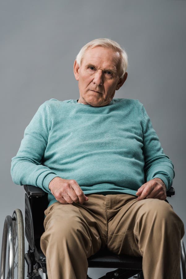 Upset Senior Man Sitting In Wheelchair And Looking At Camera Isolated