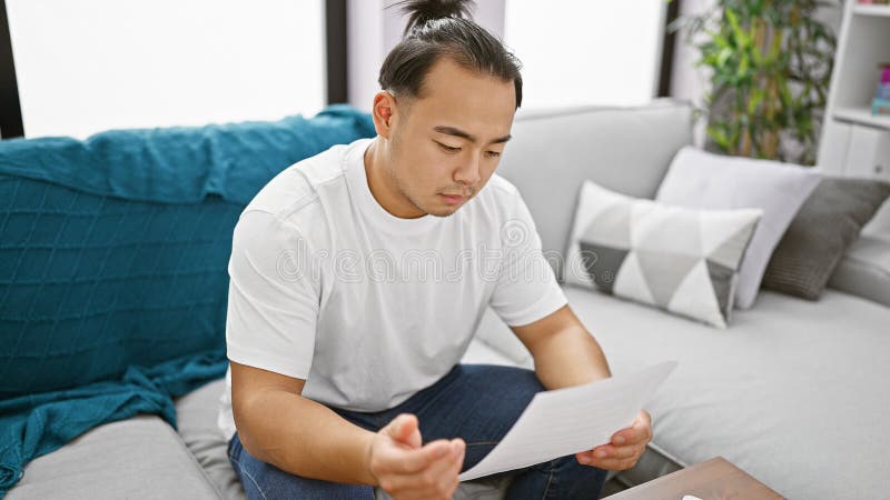 Upset Young Chinese Man with Smart Expression Intensely Reading ...