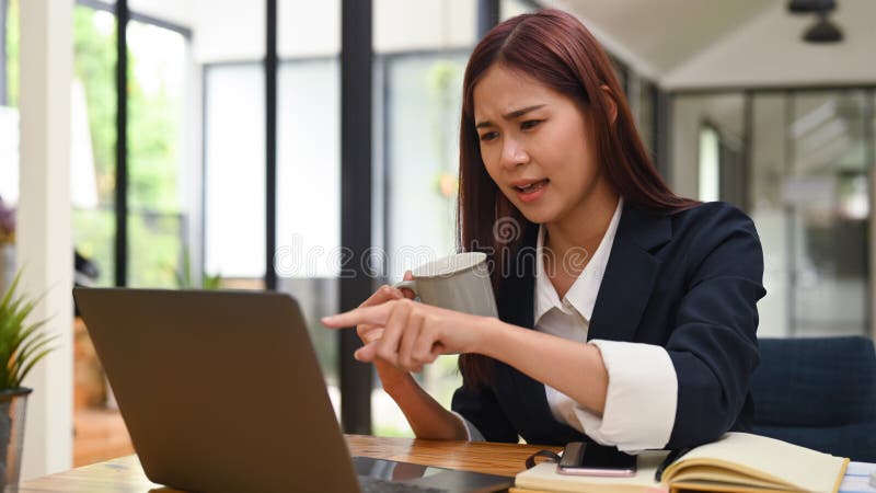 Upset Young Female Office Worker Having Problems with Laptop, Solving ...