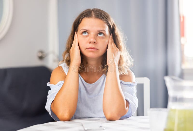 Upset Young Girl Sitting at Table in Her Room Stock Photo - Image of ...