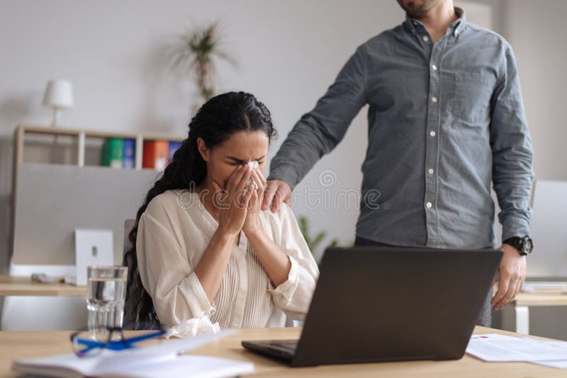Upset Young Woman Crying Near Laptop Pc At Office Male Colleague