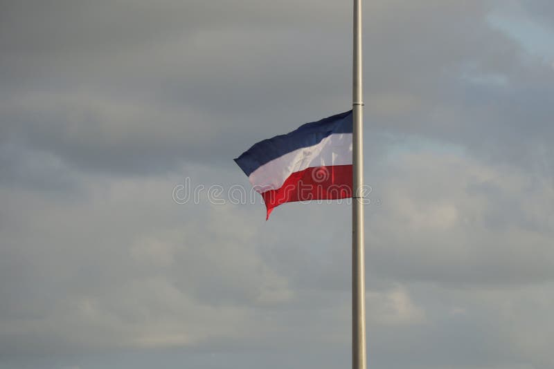 Dutch Flag Hanging on Lamp Post Against a Cloudy Sky Stock Image ...