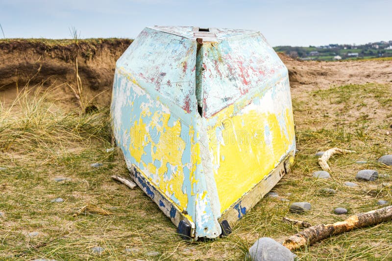 An Upturned Small Boat Washed Up on the Shoreline of a Beautiful ...