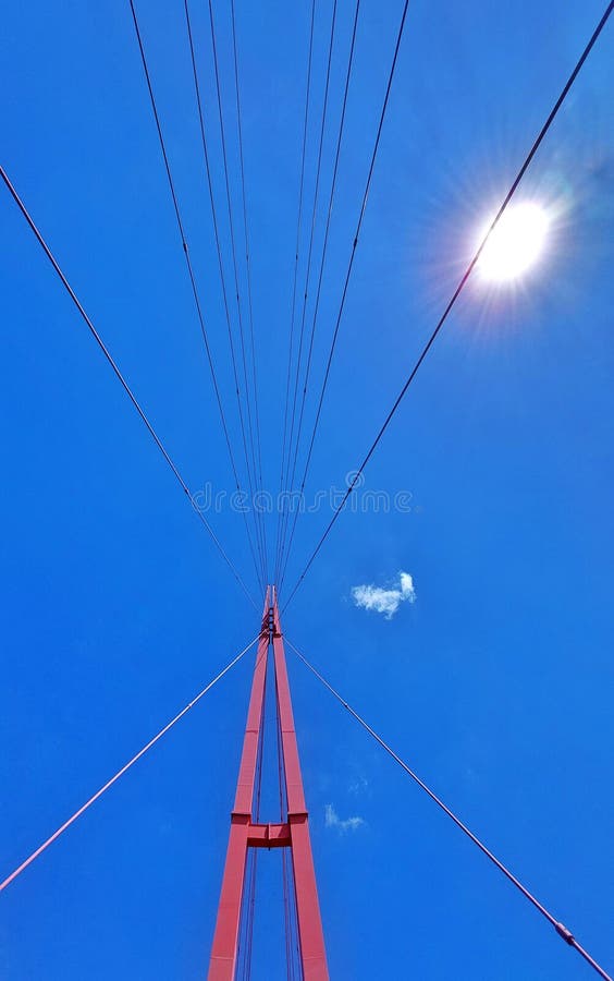 Upward Shot from Modern Suspension Bridge with Sun and Blue Sky Stock ...