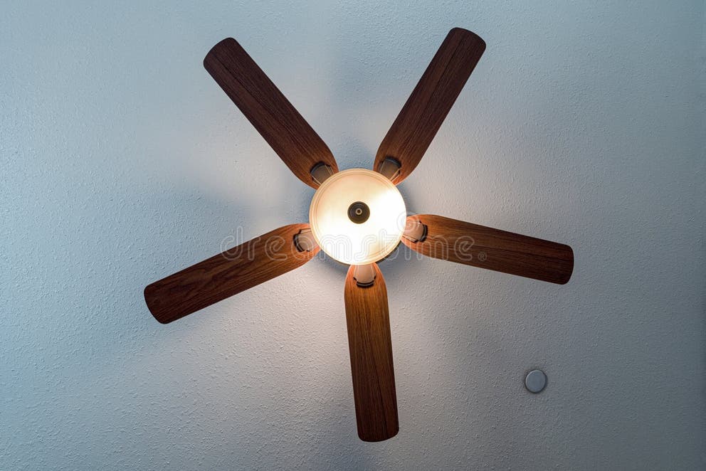 Upward View of a Ceiling Fan with an Illuminated Lamp Stock Photo ...