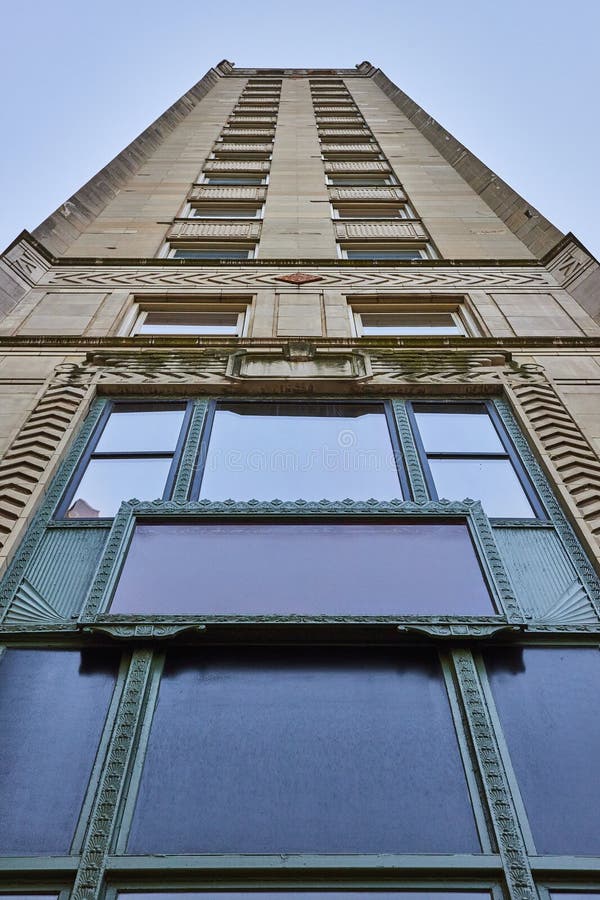 Upward View of Side of Skyscraper Building with Windows Reflecting Blue ...