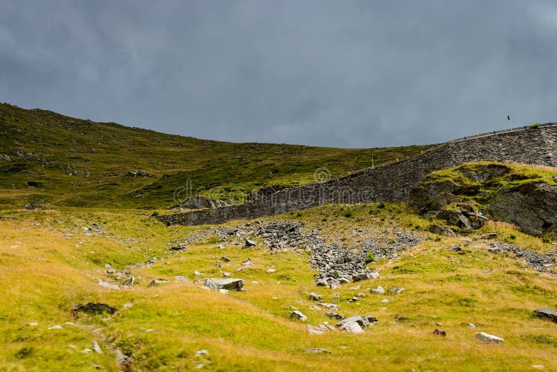 Upwards View of a Mountain Road Railing with Fallen Rocks in the ...