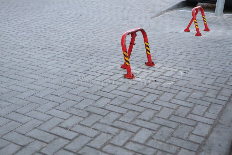 Red Safety Barriers Positioned on a Paved Surface for Enhanced Safety ...