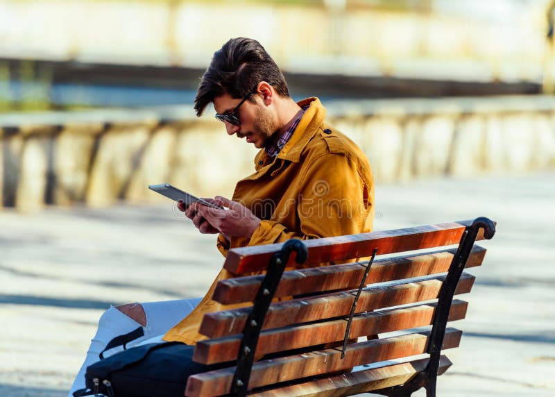 Urban Businessman Looking at His Tablet Stock Image - Image of bench ...