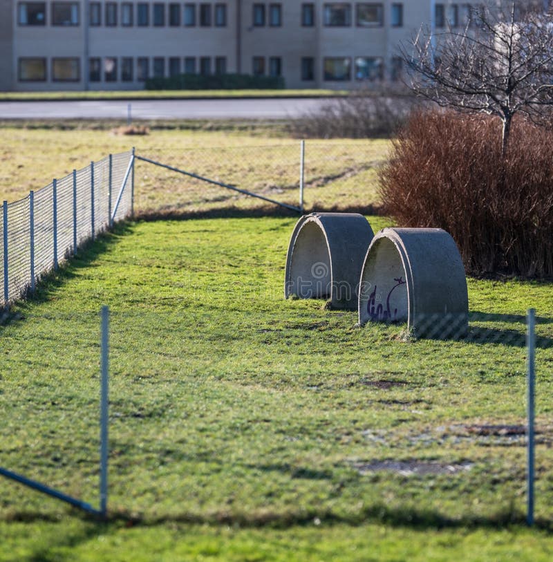 Urban Dog Park with Concrete Tunnels.. Stock Image - Image of grass ...