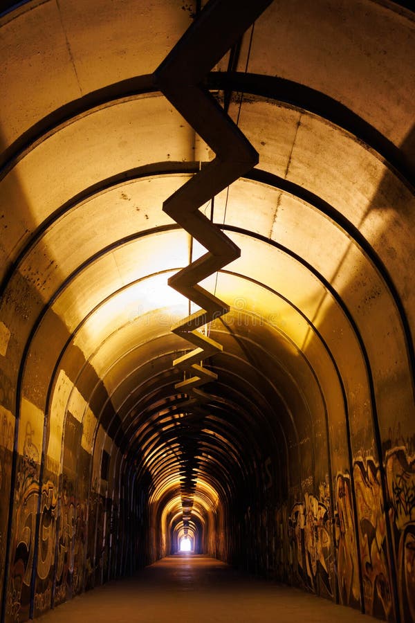 Urban, Graffiti-covered Tunnel with Zigzag Installation and Warm Lights ...