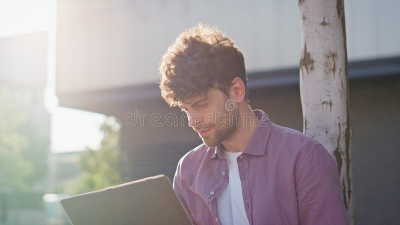 Urban Guy Typing Laptop in Sunlight Closeup. Focused Freelancer Working ...