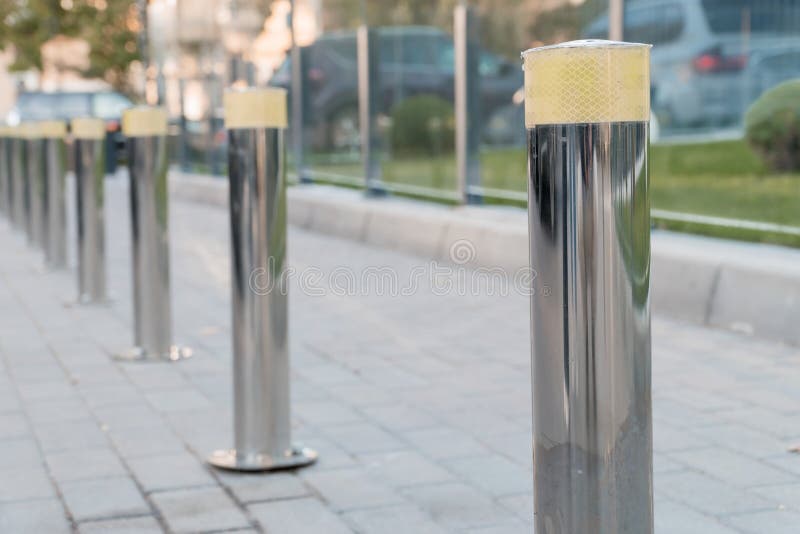 Urban Modernity: a Row of Gleaming Reflective Bollards in a City ...