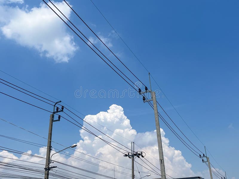 Urban Power Lines Against a Bright Blue Sky with Cumulus Clouds Stock ...
