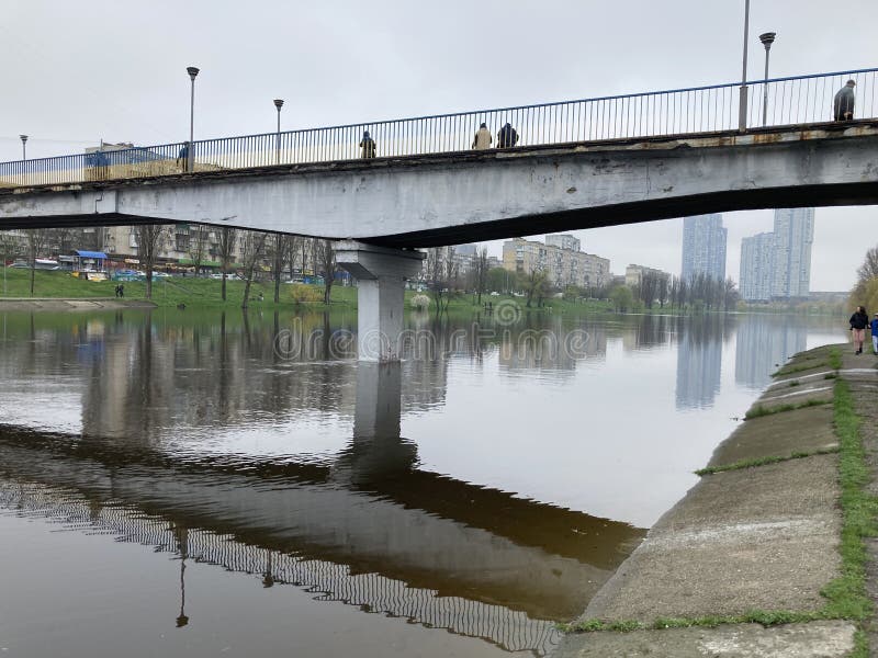 An Urban Riverfront Image with a Calm, Muddy or Silty River Reflecting ...
