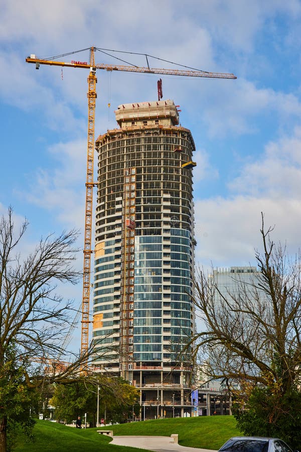 Urban Skyscraper Construction with Crane in Park Setting Stock Photo ...