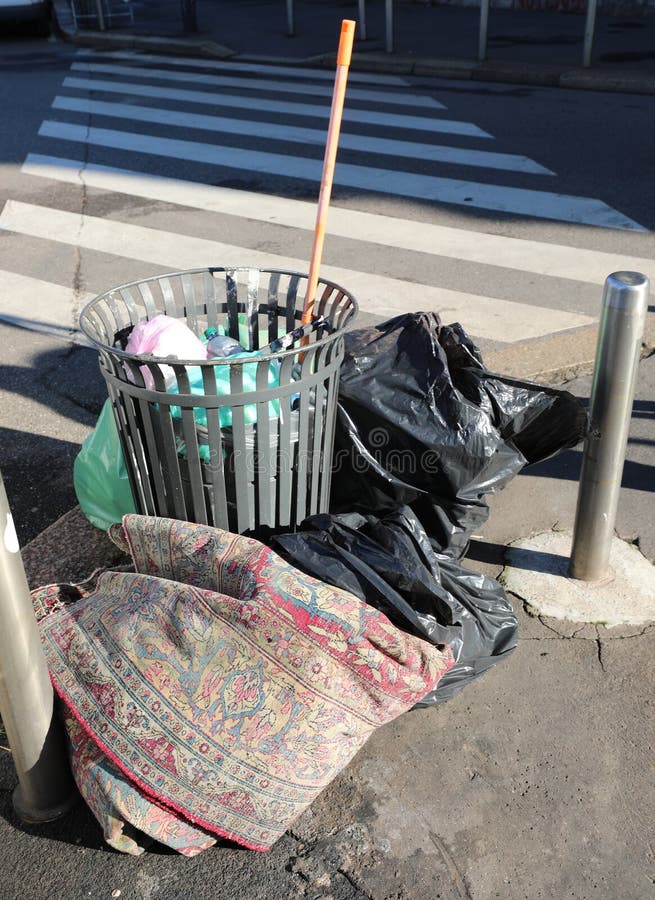 Urban Trash Bin Full of Garbage and an Old Worn-out Carpet Carelessly ...