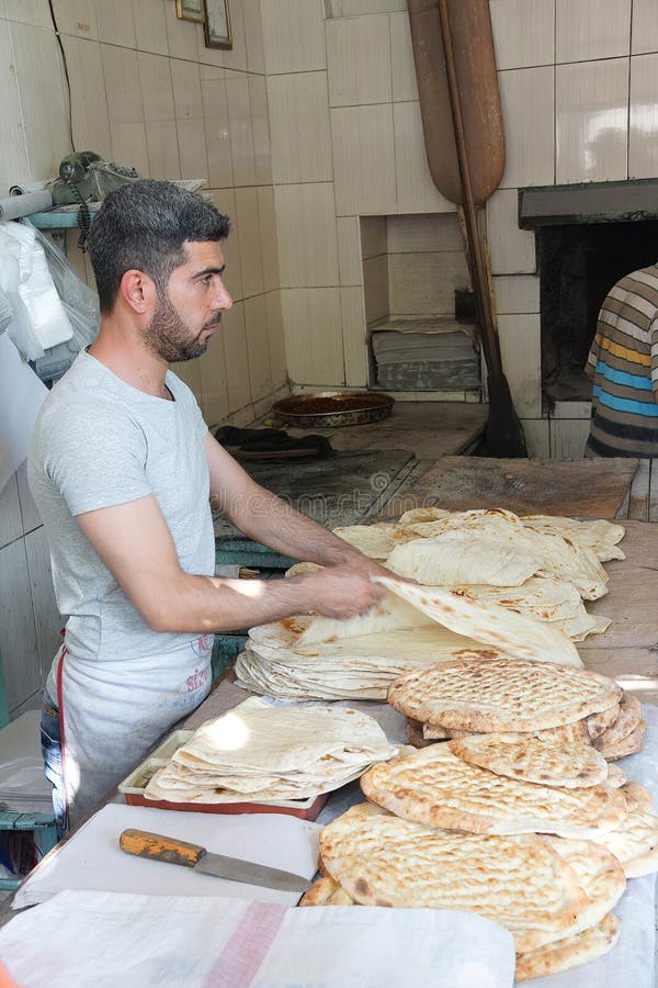 Baker prepares flatbread editorial photo. Image of bakery - 279921496