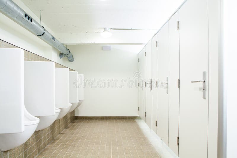 Urinal and toilet doors stock photo. Image of public - 233579888