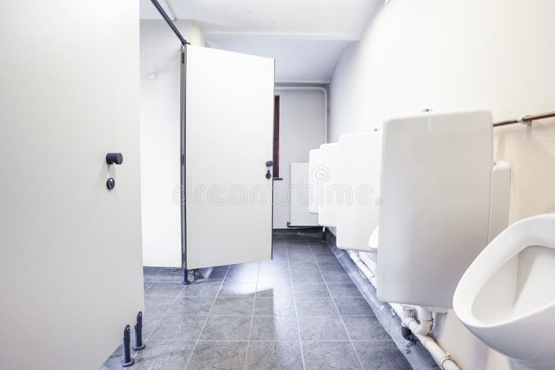 Urinals and Doors in Public Restrooms Stock Photo - Image of indoors ...
