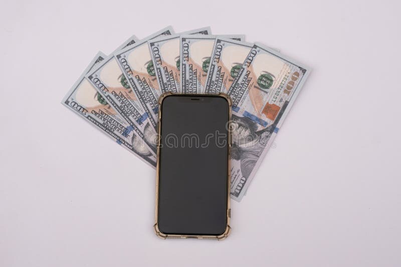 US Dollars Bills or Bank Notes Placed Under Mobile Phone. Isolated on a ...