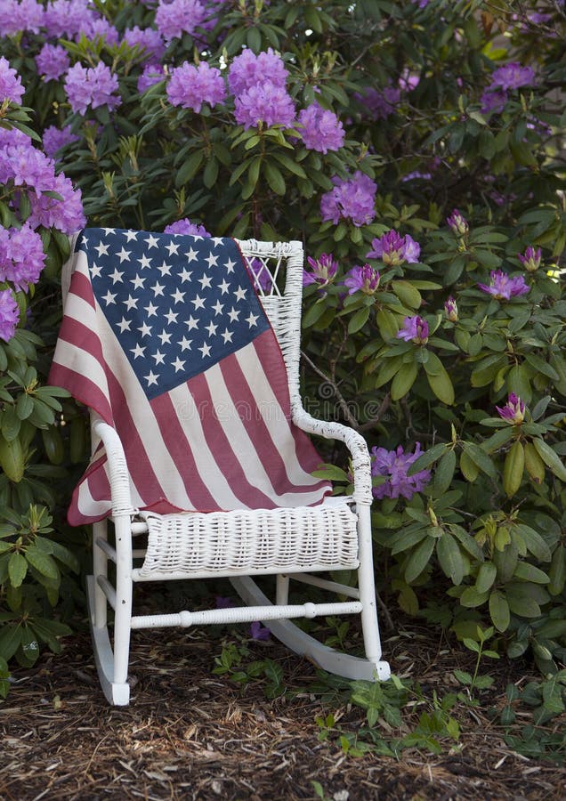 US Flag Draped on a Antique White Wicker Chair Stock Photo - Image of ...