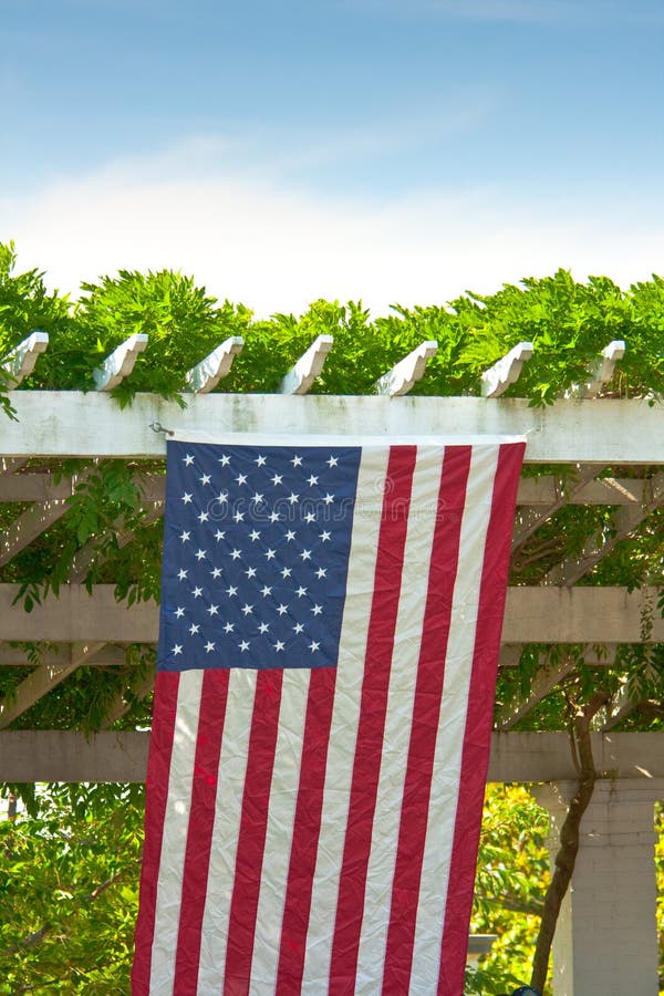 US Flag Hanging from Arbor stock image. Image of taps150 - 24877413