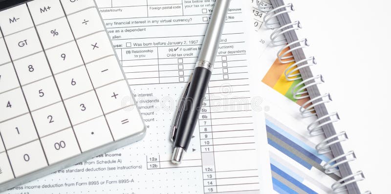 US Individual Tax Return Form 1040 with Calculator, Pen and Charts ...