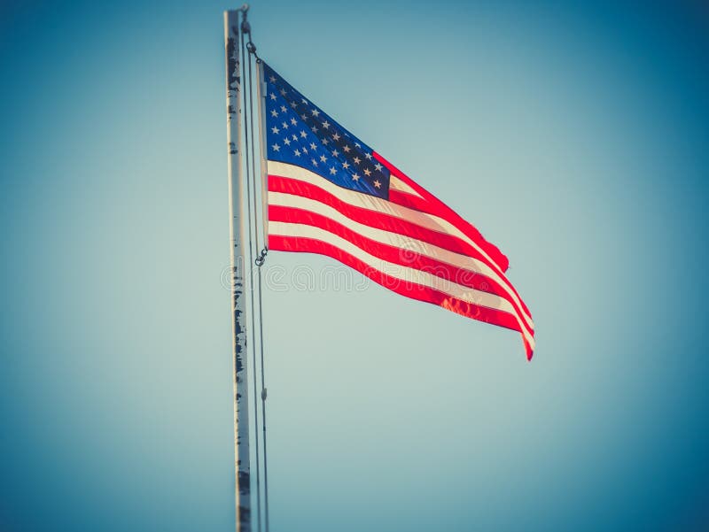 USA Flag Waving in the Air on a Pole Stock Photo - Image of gate, blue ...