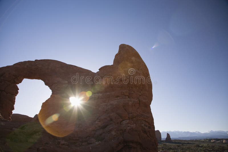 USA Sun Shining through Rock Formation in Desert Stock Image - Image of ...