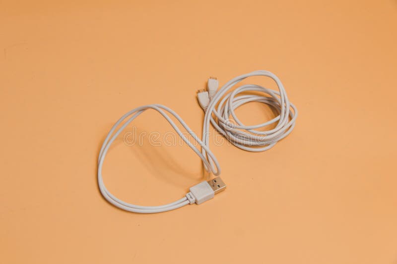 USB Cable for Smartphone on Beige Background, White Usb Cable on Beige ...