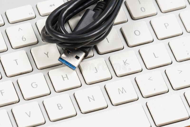 USb Cable Wrapped Around White Computer Keyboard Stock Image - Image of ...