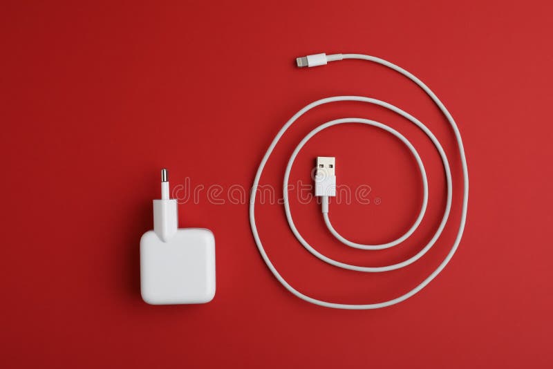 USB Charge Cable and Adapter on Red Background. Modern Technology Stock ...