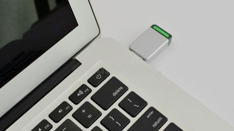 Detail of a USB Drive Next To a Laptop, Representing Portable ...