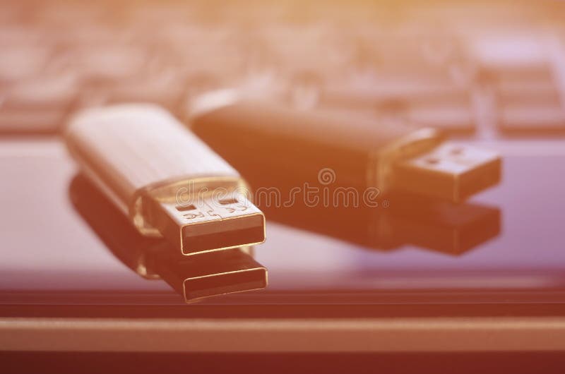 USB Flash Cards Lying on Black Laptop Case in Front of His Keyboard ...