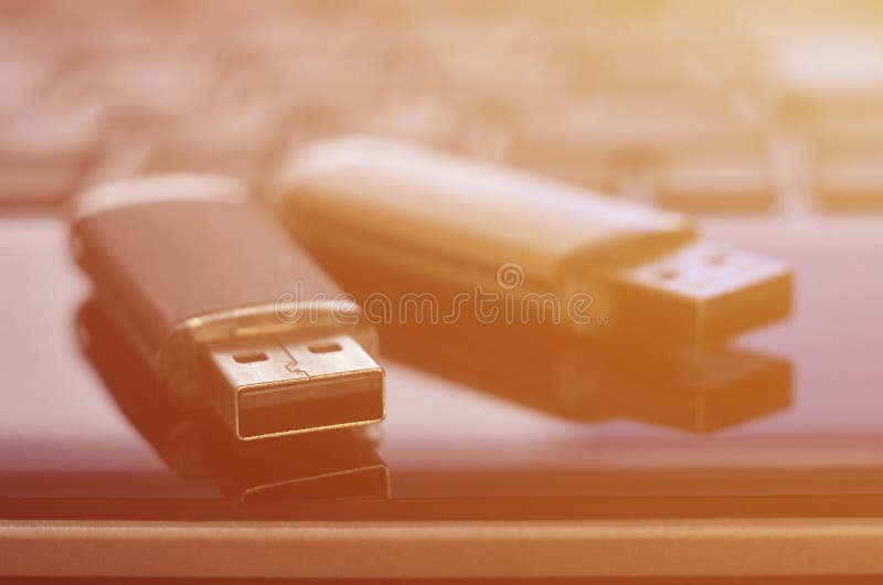USB Flash Cards Lying on Black Laptop Case in Front of His Keyboard ...