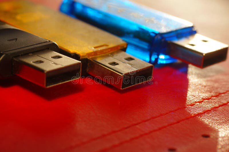 USB Flash Drive - Black, Yellow and Blue, on a Red Background. Stock ...
