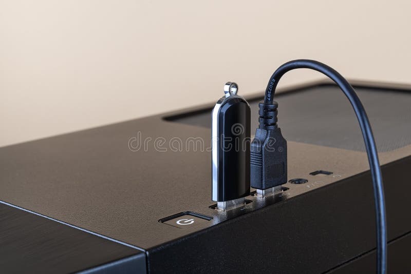 USB Flash Drive and USB Cable Both Inserted into Ports on the Top of a ...