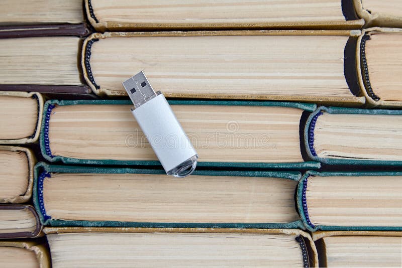 USB Flash Drive of a Computer on the Background of a Stack of Old Paper ...