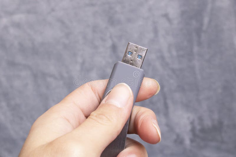 USB Flash Drive in Hand on Gray Background Stock Image - Image of flash ...