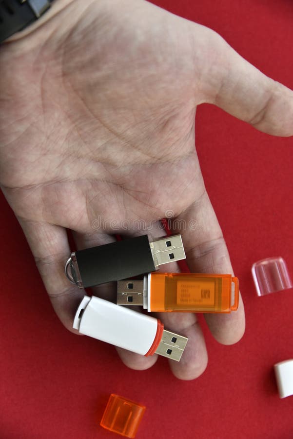 USB Flash Drive in the Palm of Your Hand on a Red Background Stock ...