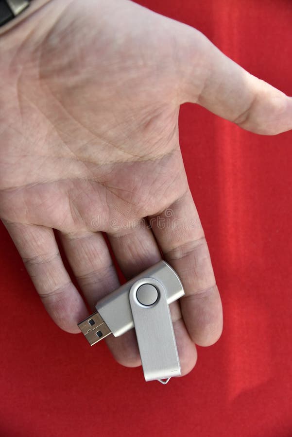 USB Flash Drive in the Palm of Your Hand on a Red Background Stock ...