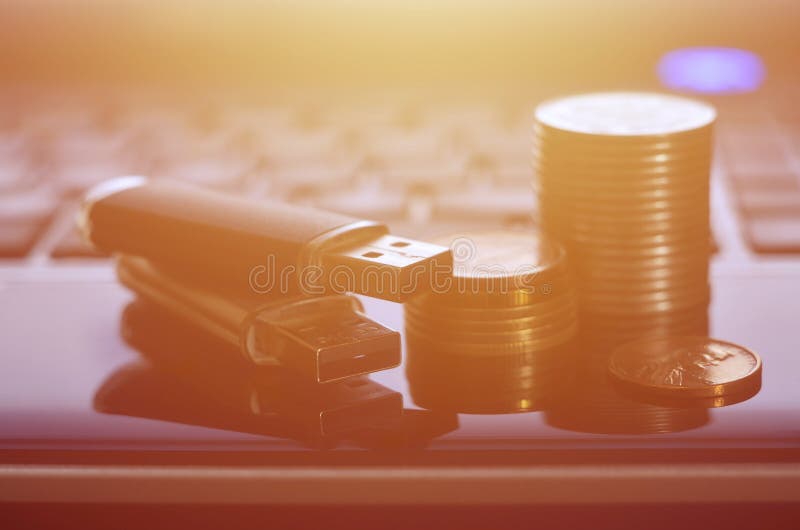 USB Memory Cards and a Few Coins Lying on the Body of Black Laptop in ...