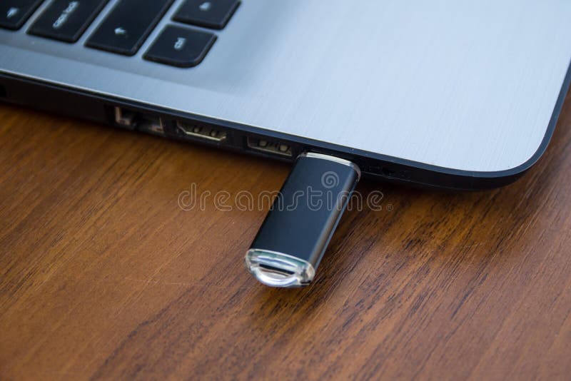 USB Memory Stick or Flash Drive Attached To the Side of a Laptop Stock ...