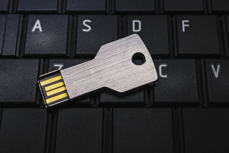 USB Memory Stick. Flash Memory Stick in the Shape of a Key on a Black ...