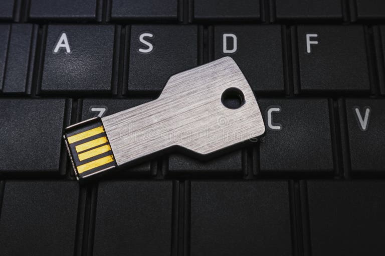 USB Memory Stick. Flash Memory Stick in the Shape of a Key on a Black ...