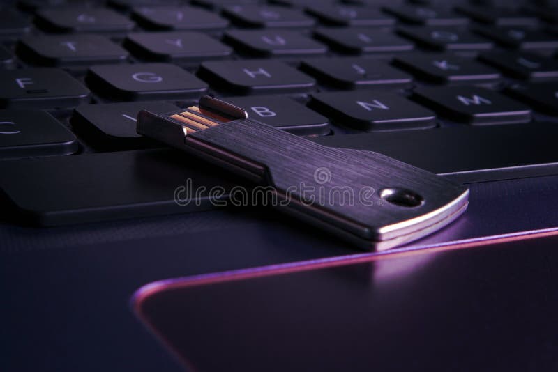 USB Memory Stick in the Form of a Key on a Laptop Keyboard Close-up ...