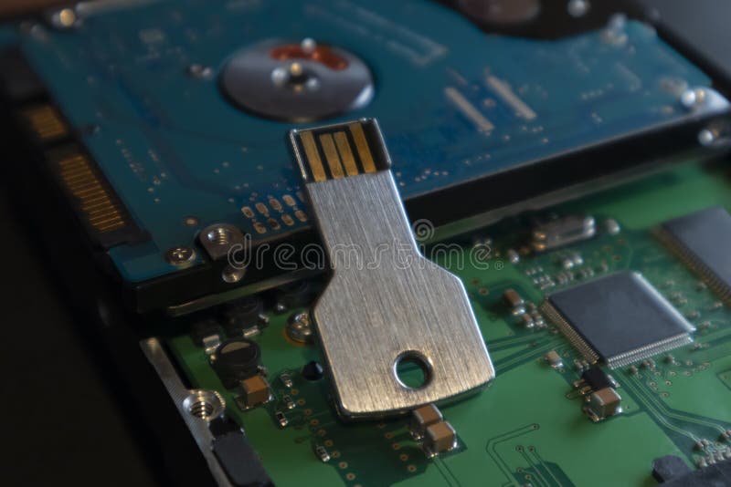 USB Memory Stick in the Form of a Key on a Blurred Hdd Background Stock ...