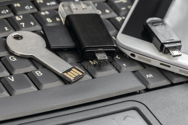 USB and Micro USB Keys with Smartphone on the Laptop Keyboard Stock ...
